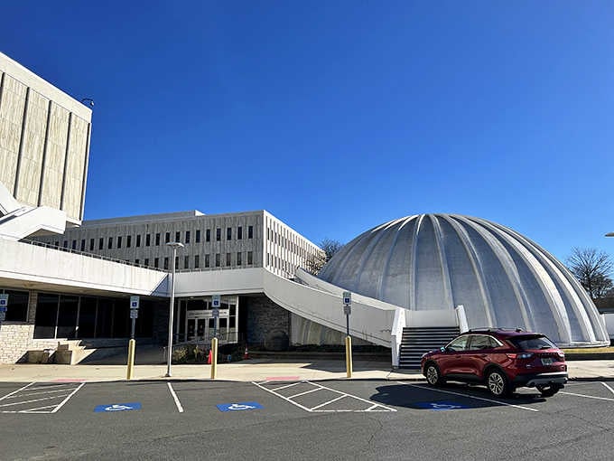 The Planetarium's distinctive dome promises cosmic adventures without requiring you to actually leave the atmosphere or state.