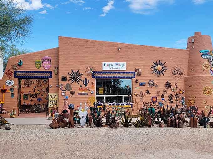 Colorful metal suns dance across this facade like a fiesta frozen in time and terracotta.