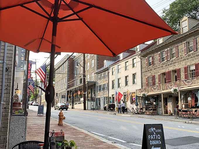 Historic Ellicott City's charming streetscape provides the perfect backdrop for your outdoor dining adventure under vibrant umbrellas.