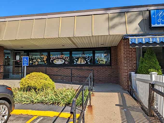 Hand-painted window signs advertising breakfast specialties are the old-school marketing that still works better than any app.