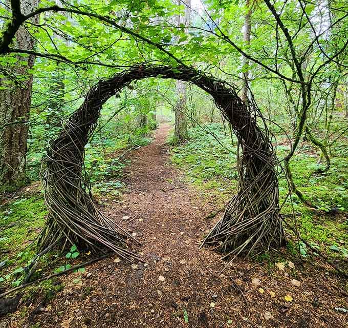 This artistic portal frames the trail ahead, turning ordinary walks into adventures worthy of fantasy novels or hobbit journeys.