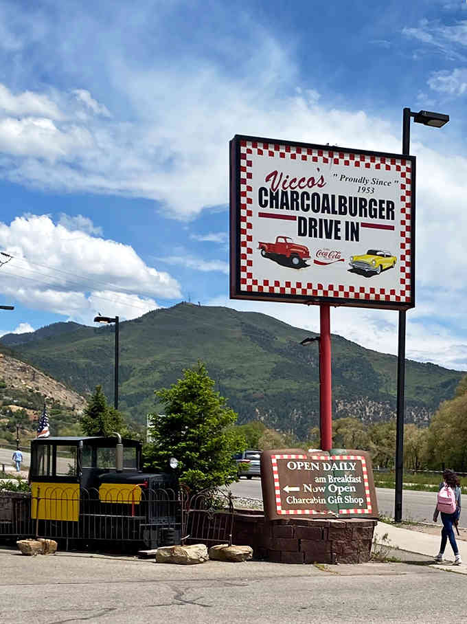 The sign proudly announces what's inside, with mountains providing the perfect backdrop for this Colorado treasure since 1953.