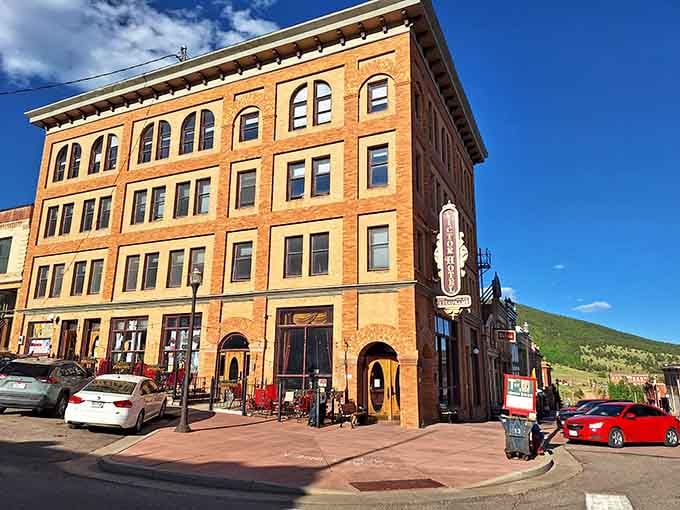 Victor Hotel's brick majesty anchors the corner, a four-story testament to boom-town ambition and survival.