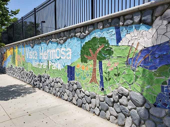 This vibrant mosaic mural celebrates the park's natural beauty with colors that pop against the urban landscape.