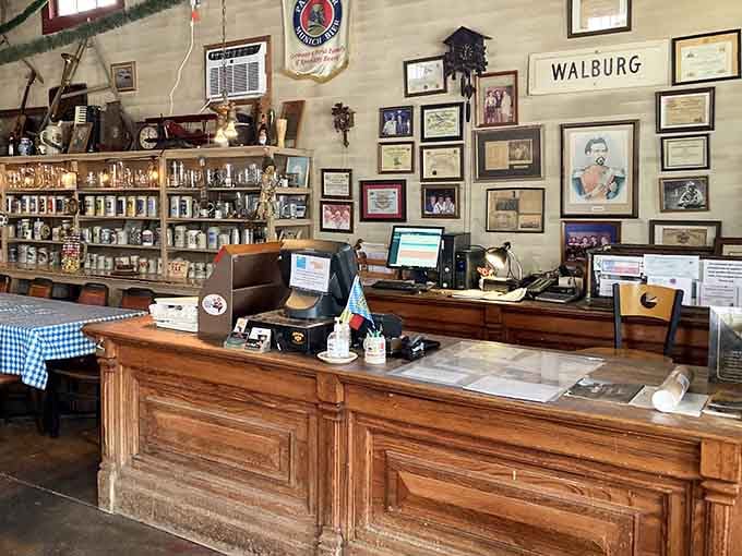 The wooden counter displays steins and memorabilia, serving as both checkout and museum of German-Texan heritage.