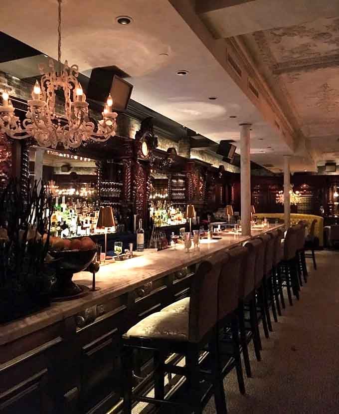 A marble bar stretching the length of the room, stocked with enough spirits to make any cocktail lover's heart skip a beat.