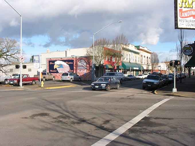 A patriotic mural brightens the streetscape where community pride shows in every freshly painted storefront and swept sidewalk.