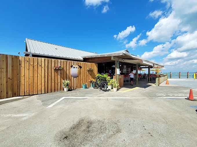 Fresh wood siding and that cheerful awning welcome you to waterside dining that feels like a mini vacation.