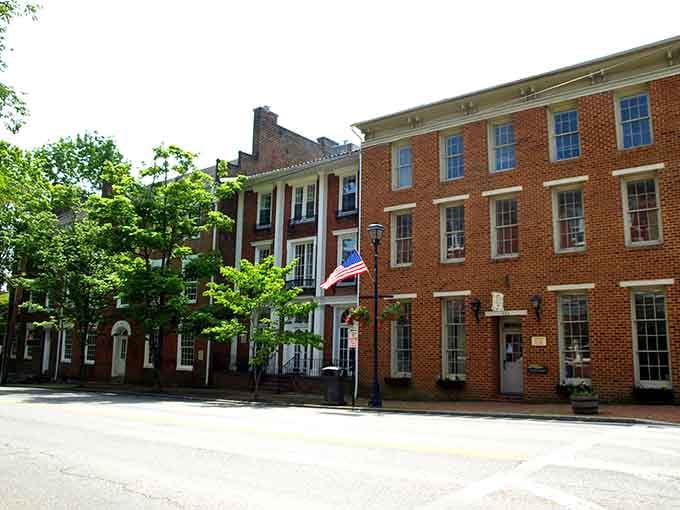 Historic brick buildings line peaceful streets where American flags still wave with genuine pride and community spirit shines.