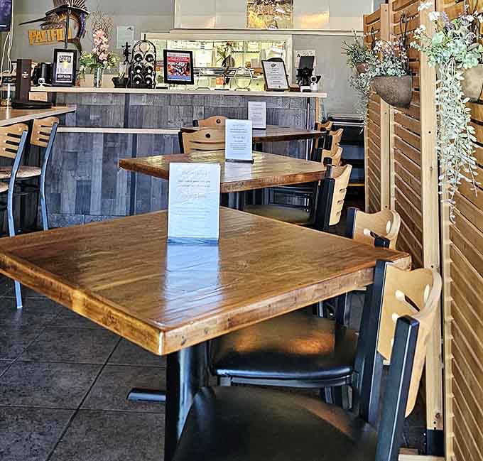 Wooden tables and booth seating offer choices for every dining mood, from intimate to social gatherings.