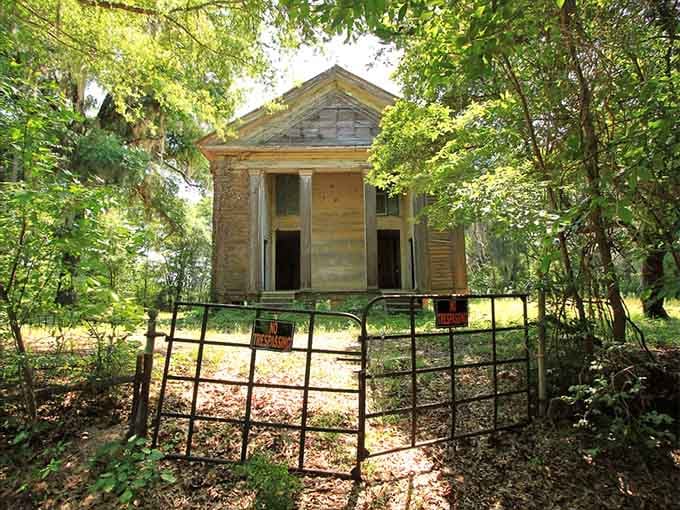 The gate stands open like an invitation, though the "No Trespassing" signs suggest some stories prefer to keep themselves.