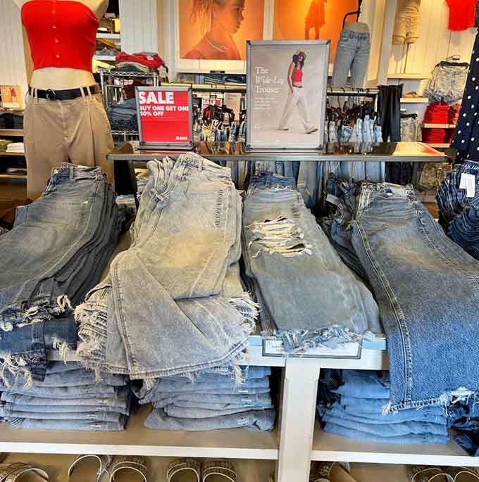 Denim stacks so perfectly folded they look like modern art, except you can actually wear them.
