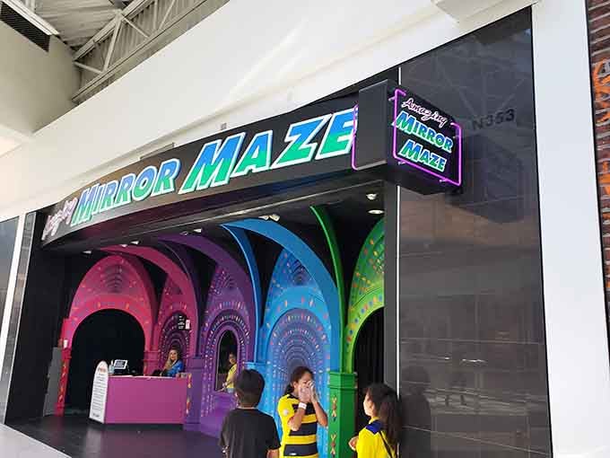 Those colorful arches beckoning from the entrance are your last glimpse of reality before geometry gets wonderfully weird.