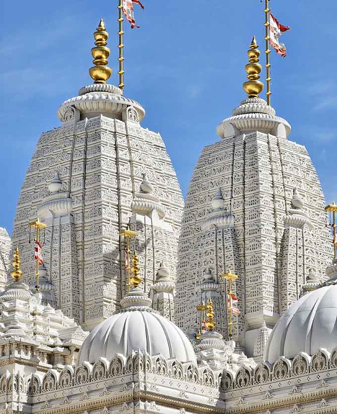 Temple towers topped with golden finials reaching skyward, their intricate carvings visible even from this breathtaking perspective below.