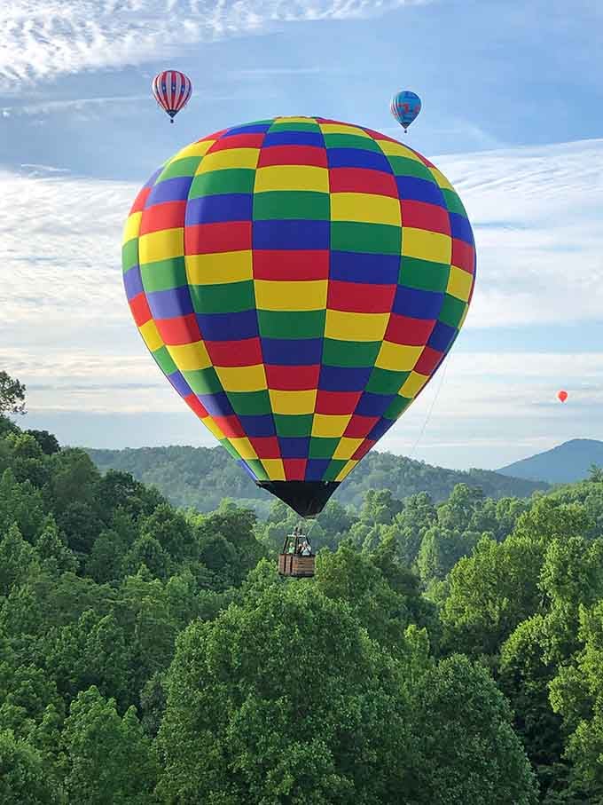 Floating over emerald forests with mountain silhouettes beyond, this is what "room with a view" really means.