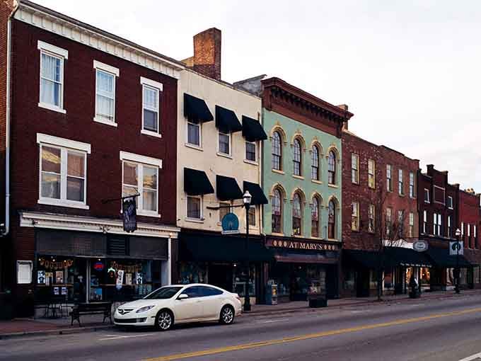 The varied storefronts create a streetscape more colorful than a box of crayons, each building telling its own story.