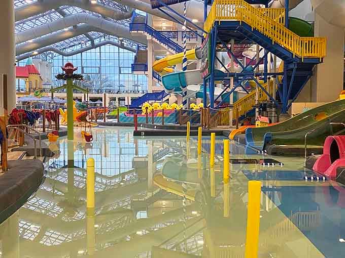 Bright yellow play structures create a splash zone where giggles echo louder than the sound of cascading water.