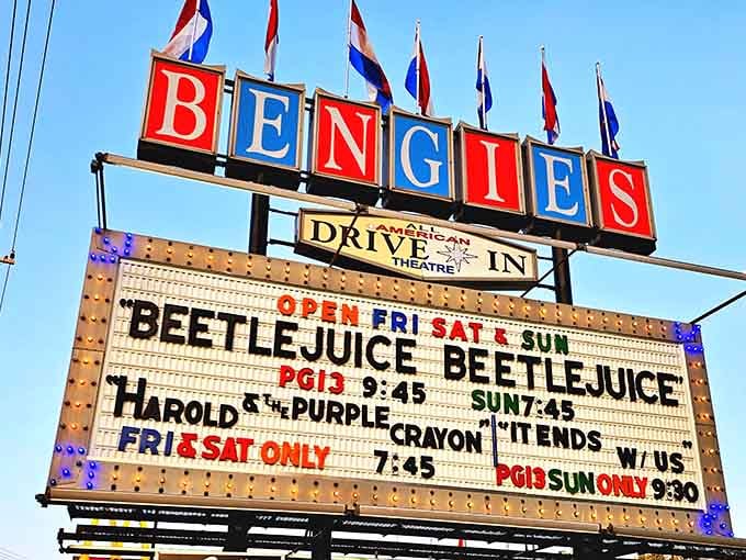 The classic marquee announces tonight's features like a promise of adventure waiting just beyond the entrance gate.