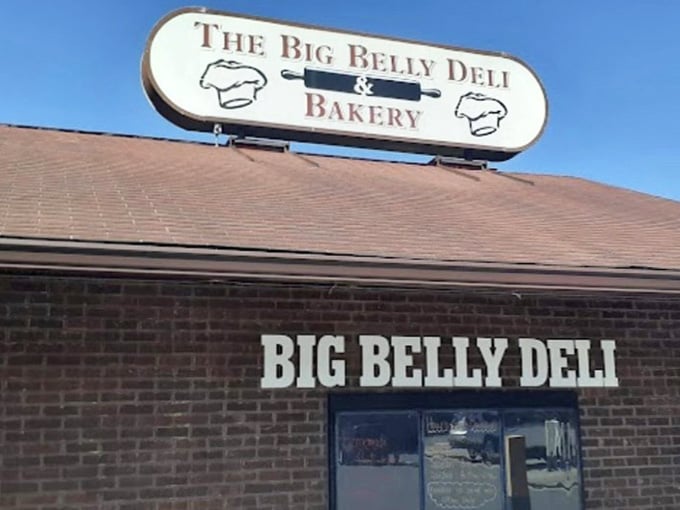 The Big Belly Deli sign stands proud against blue sky, marking the spot where hunger meets satisfaction.