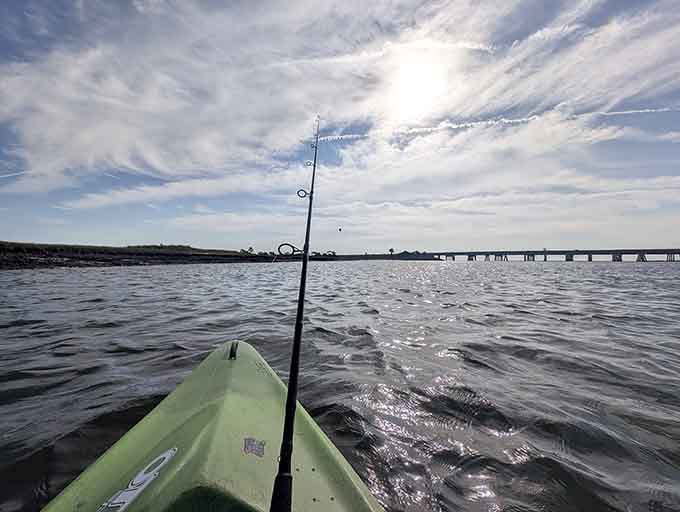 Kayak fishing in calm waters offers peaceful solitude and the possibility of dinner, double win.