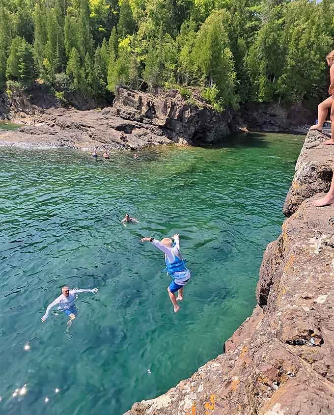 Summer brings the brave souls who launch themselves into the crystal-clear depths, creating memories and minor heart attacks.