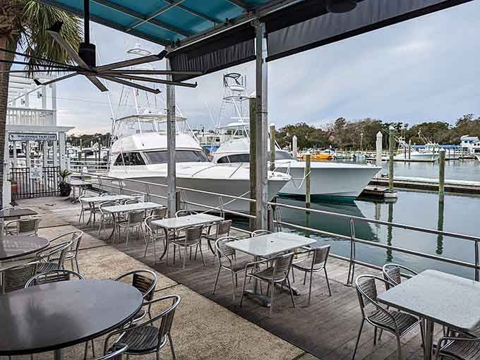 Outdoor patio seating where you can watch boats glide by while deciding whether to order another round or dessert.