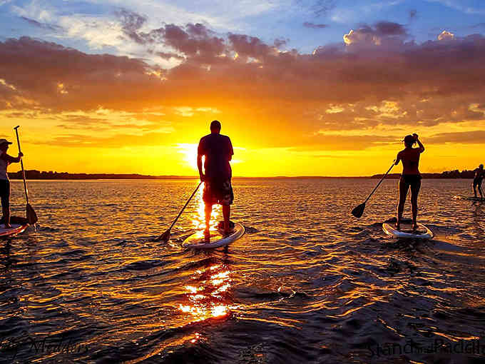 Paddleboarding into golden hour sunsets provides free therapy that's more effective than anything requiring a co-pay or prescription.