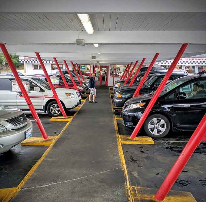Covered parking spots with those iconic red supports: your car gets the VIP treatment while you feast inside.