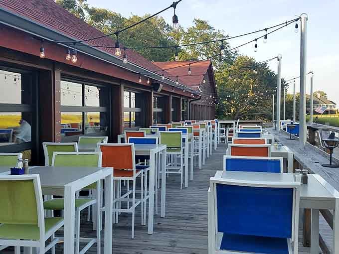Colorful outdoor seating along the deck turns every meal into a waterfront celebration worth remembering fondly.