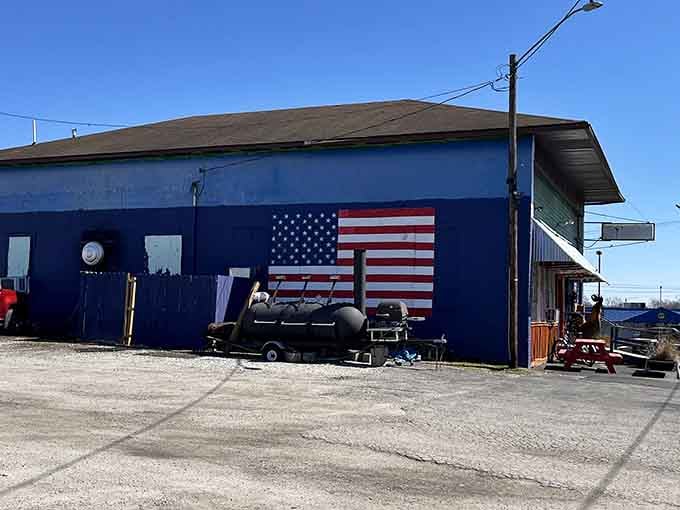 The side of the building proudly displays an American flag, with a smoker standing ready for barbecue duty.