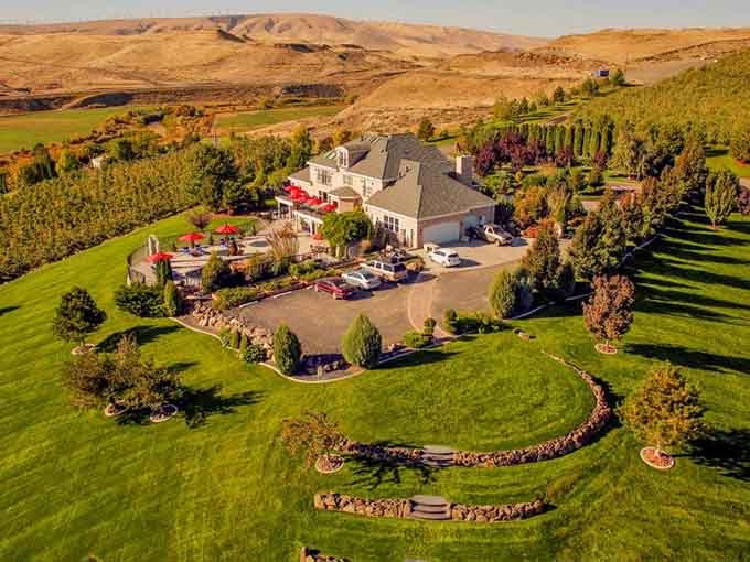 Aerial perspective reveals manicured grounds surrounding this dining destination that defies all rural restaurant expectations completely.