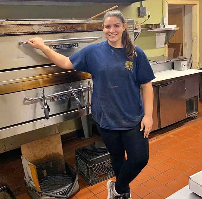 Behind every great pizza is someone who knows their way around dough, and this smile says it all.