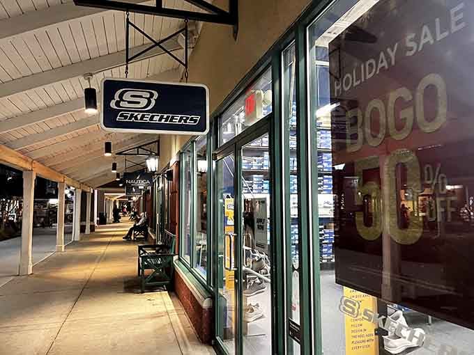 Evening falls on the outdoor walkways, but the shopping possibilities remain endless under those welcoming storefront lights ahead.