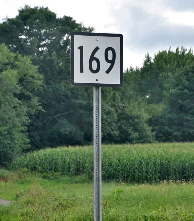That simple Route 169 sign marks your gateway to one of America's most beautiful and historically significant scenic byways.