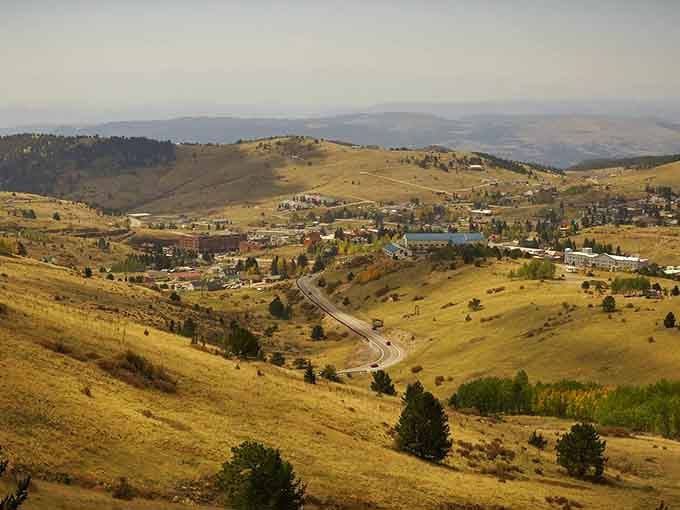 The town nestles in its mountain bowl like a secret someone forgot to keep, surrounded by peaks and possibility.