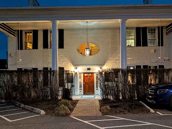 Evening lights transform this entrance into something magical, proving good architecture looks stunning regardless of the hour or decade.