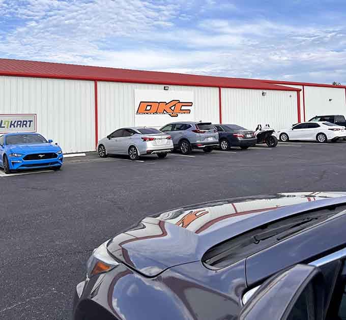 The parking lot where regular cars rest while their drivers experience what real speed feels like inside.