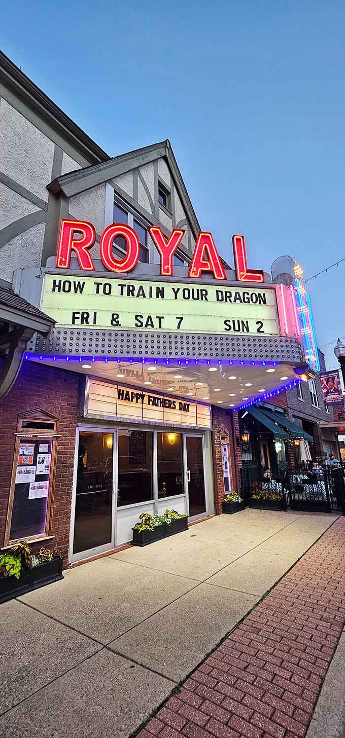 The Royal Theater's neon sign glows like a beacon, proving that small-town entertainment venues can outshine any multiplex's charm.