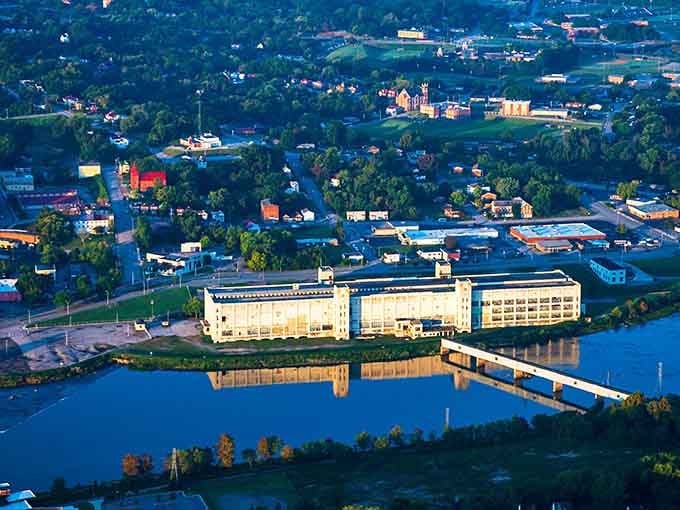 Aerial view reveals the Dan River curving through town, reflecting buildings that tell stories of reinvention and resilience.