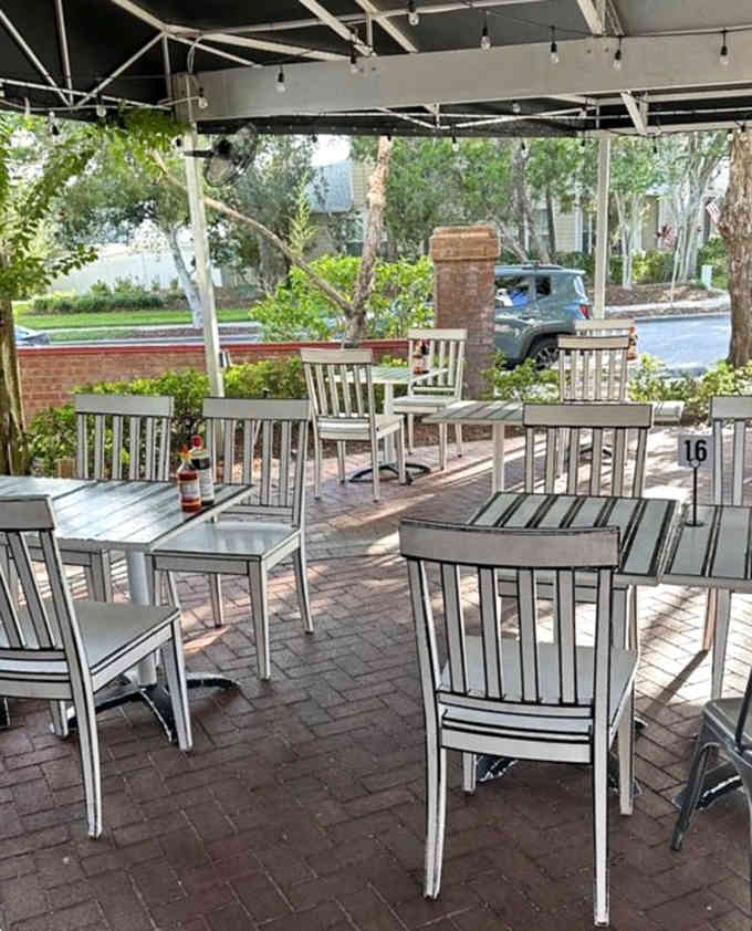 The outdoor patio extends the illustrated theme, because apparently even fresh air needs to look hand-drawn here.