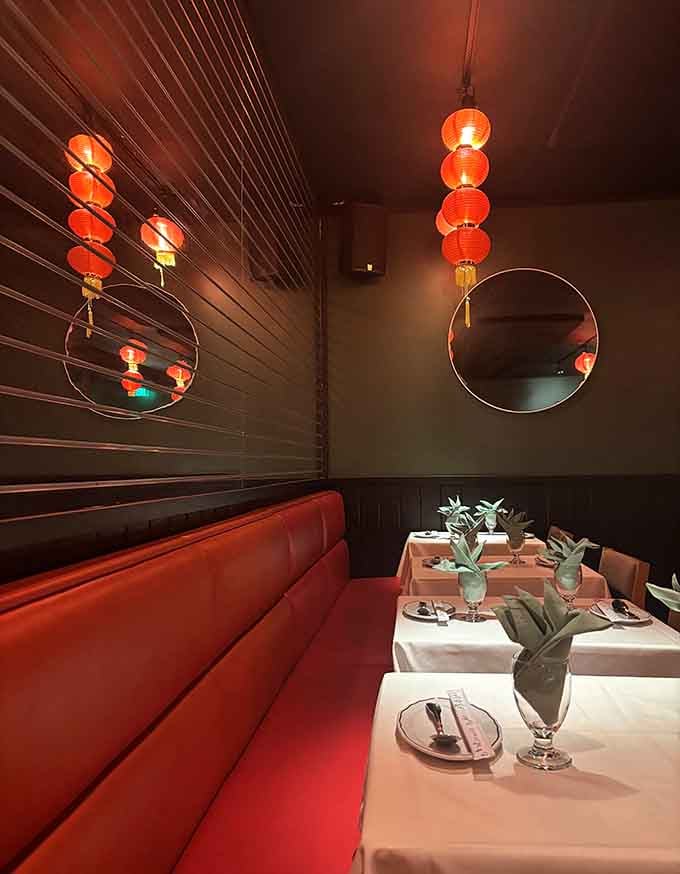 Plush red booths and dramatic lighting create intimate dining spaces perfect for sharing multiple dishes with your favorite people.