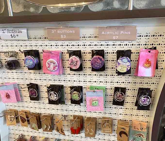 Even the merchandise gets the fantasy treatment with pins and keychains for those who want souvenirs from their adventure.