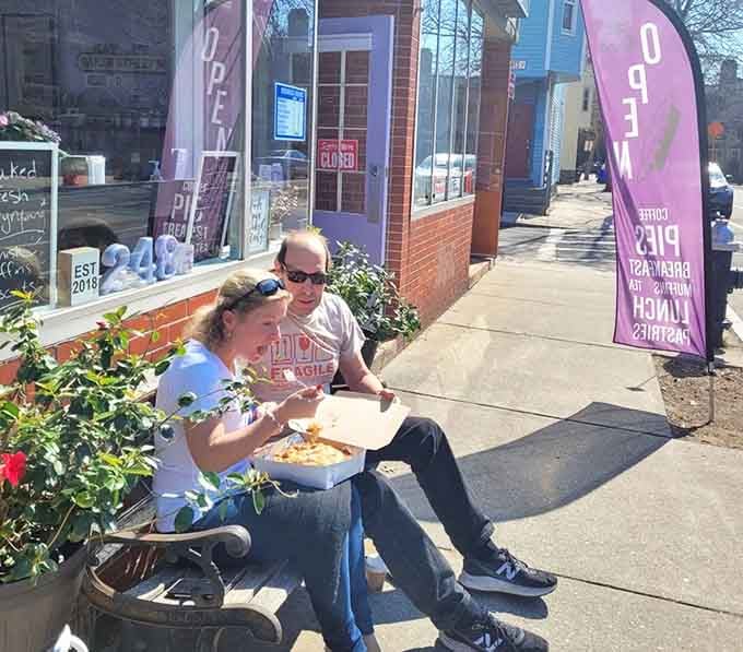 Sidewalk pie consumption is a perfectly acceptable life choice, as these happy customers clearly understand and demonstrate.