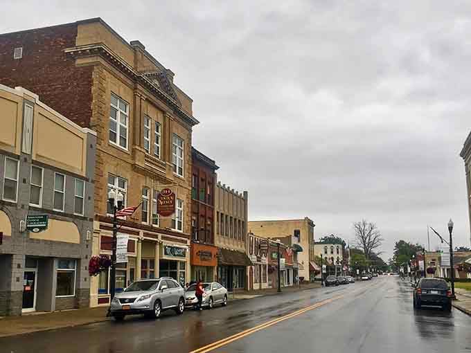 Rainy days on Central Avenue create moody scenes where vintage buildings shine despite weather that forgot summer exists.