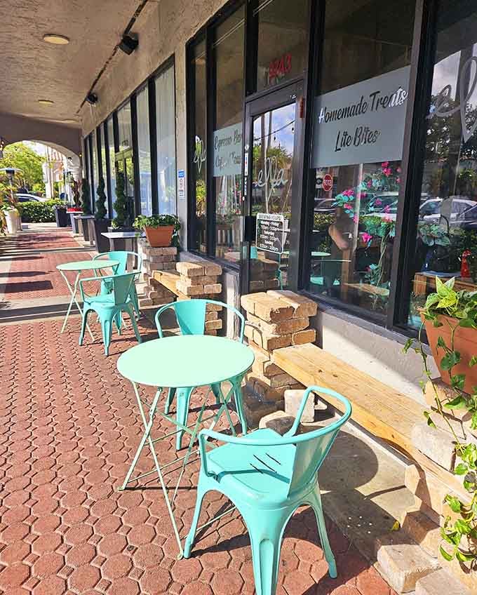 Turquoise chairs on brick pavers invite you to enjoy your coffee al fresco like a civilized human being should.