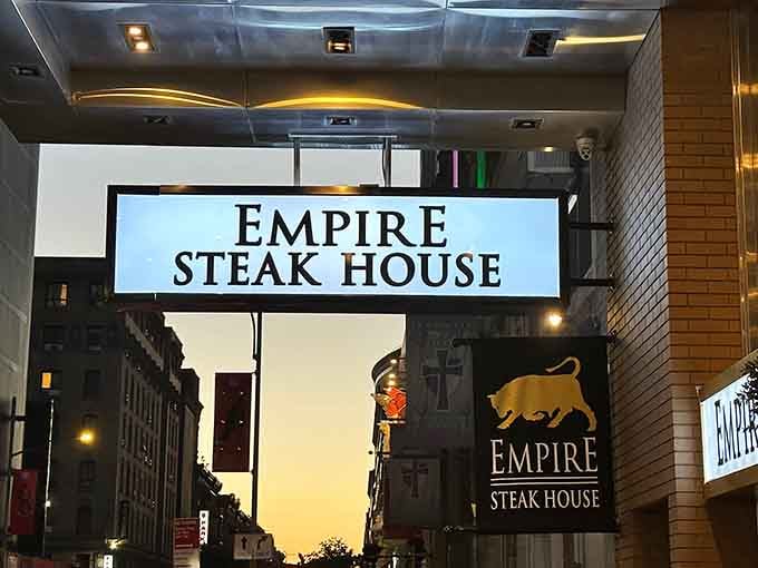 The illuminated signage at dusk promises refuge from Times Square chaos and delivers on that promise spectacularly.