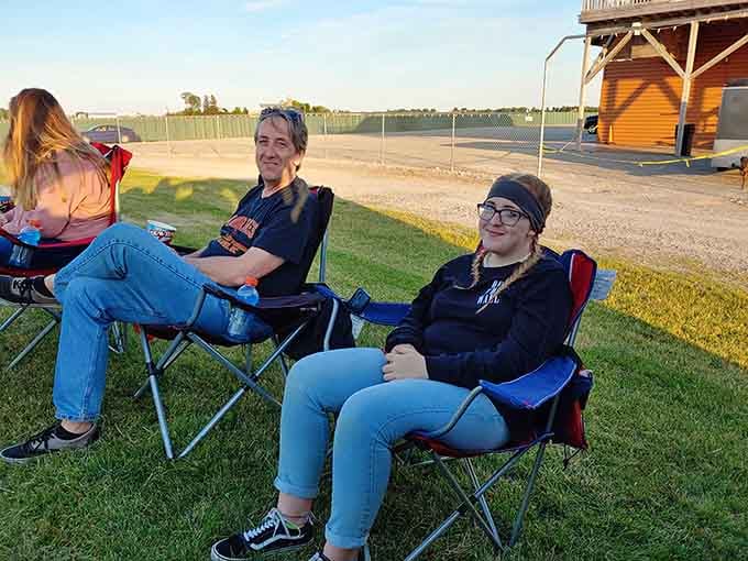 Friends relaxing before the show, soaking up the last rays of daylight before the movies begin.