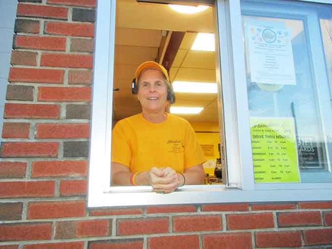 The friendly face behind the window represents generations of baking expertise and genuine hospitality.