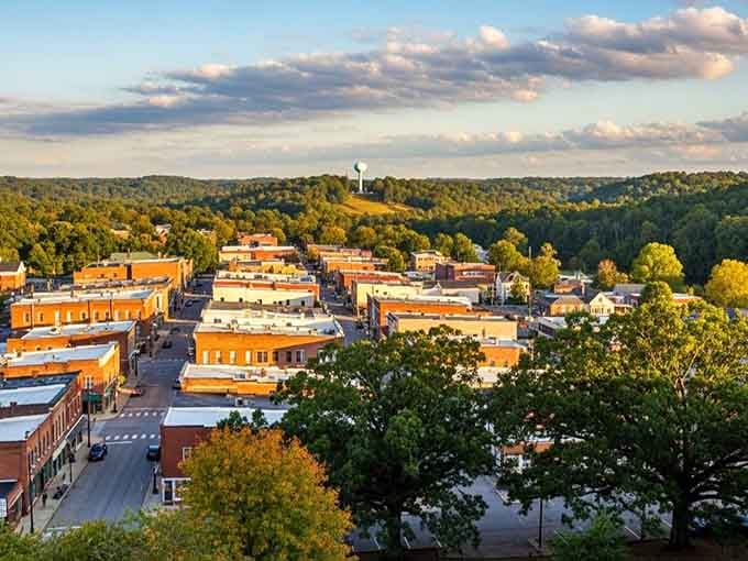 Rooftops stretch toward rolling hills as late afternoon light paints this small town in shades of amber and gold.