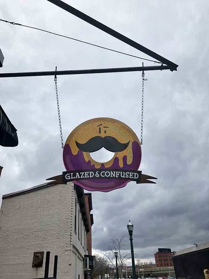 The mustachioed donut mascot swinging overhead watches over Syracuse like a delicious, glazed guardian angel with serious style.